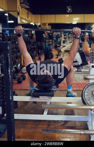 A man is intensely focused on lifting weights at the gym Stock Photo ...