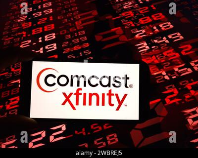 Comcast logo on mobile phone , background is a keyboard , Sydney ...