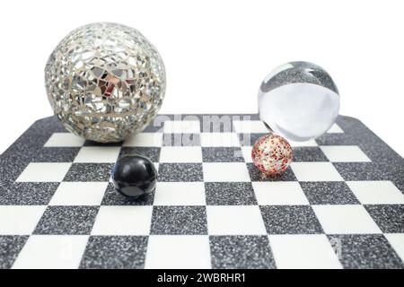 Glass lens ball on a marble chess board, soft focus Stock Photo - Alamy