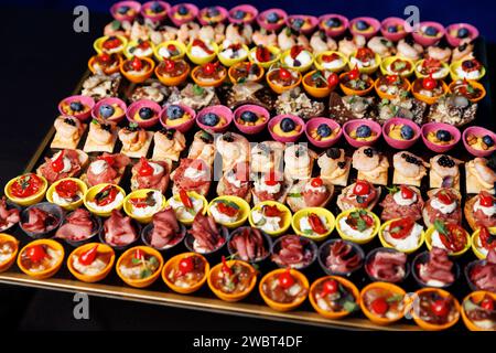 A set of small different snacks. Bite-sized catering canapes Stock ...