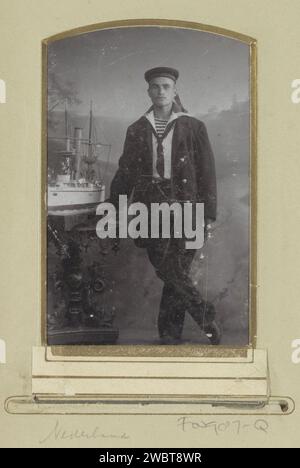 Portrait of a (presumably) Dutch sailor, standing by a fireplace ...