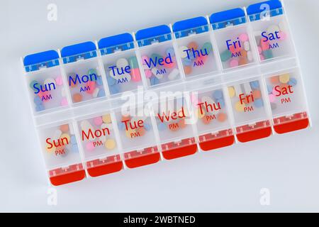 An weekly organizer box for dispensing medications on white background ...