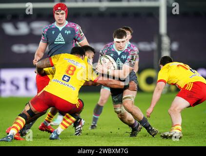 Ospreys' Morgan Morse (centre) is tackled by USA Perpignan's Sootala ...