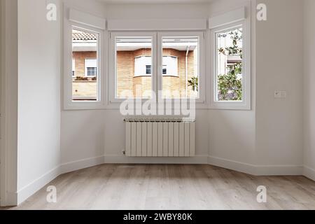 An empty room with a gallery full of windows overlooking the ...