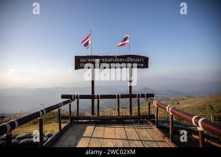 A sign depicting the Thai-Myanmar border with Thailand flags on top ...