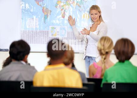 School kids pointing at map in classroom Stock Photo - Alamy
