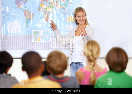 School kids pointing at map in classroom Stock Photo - Alamy