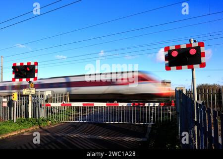 An Azuma train passing red lights at an unmanned Level crossing, East ...