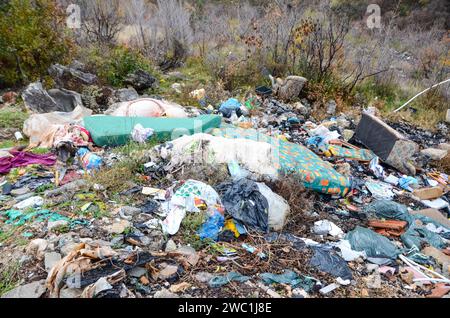 Wild garbage dump in nature. Open landfill site. Pile of garbage ...