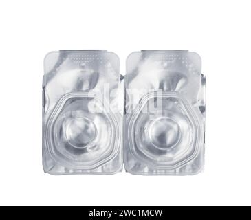 Storage container for soft contact lenses and solution bottle on table ...