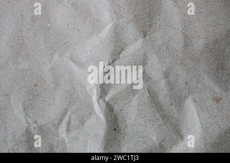 Background from used crumpled gray wrapping paper. Light gray ...