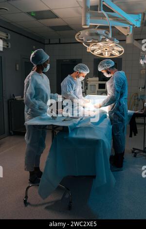 Multiethnic surgical team work in operating room using futuristic ...