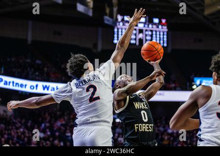 Wake Forest guard Kevin Miller is defended by North Carolina guard ...