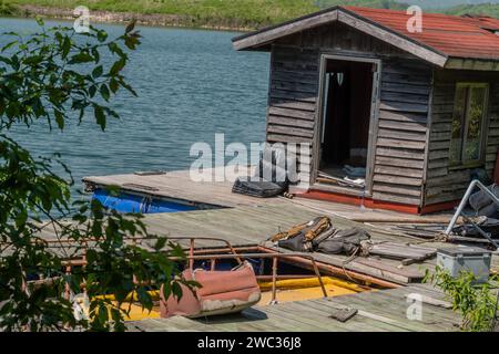 Old abandoned fishing shack and dock floating on surface of lake Stock ...
