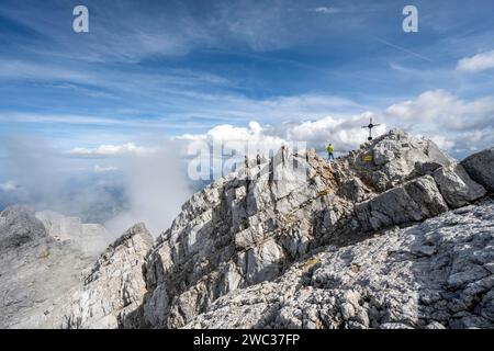 Mountaineer on the rocky summit of the Watzmann Mittelspitze with ...