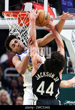 Golden State Warriors forward Trayce Jackson-Davis, left, shoots ...