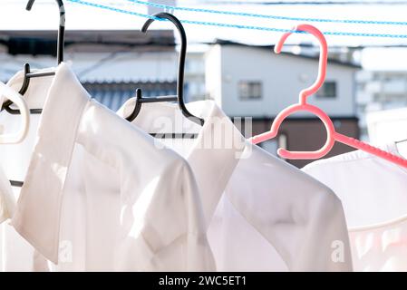 Drying clothes in the sun using a laundry rope that keeps clothes ...
