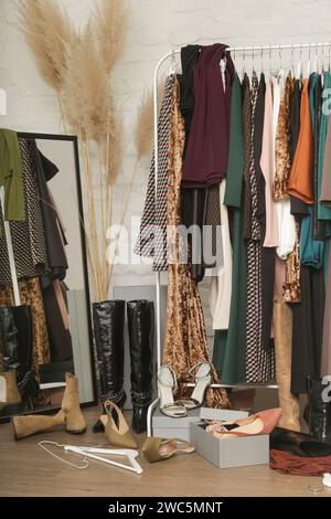 Untidy cluttered woman wardrobe with stylish clothes and accessories ...