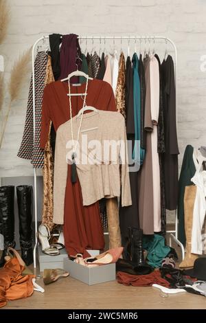 Untidy cluttered woman wardrobe with stylish clothes and accessories ...
