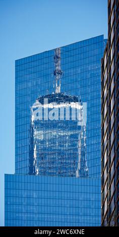 4 World Trade Center, with its highly reflective glass curtain wall ...