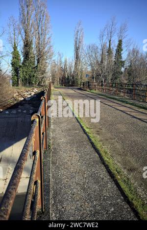 Crossroads between a dirt path and a bridge Stock Photo - Alamy