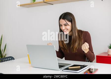 Overjoyed young businesswoman feeling euphoric about job promotion, smiling with eyes closed ...