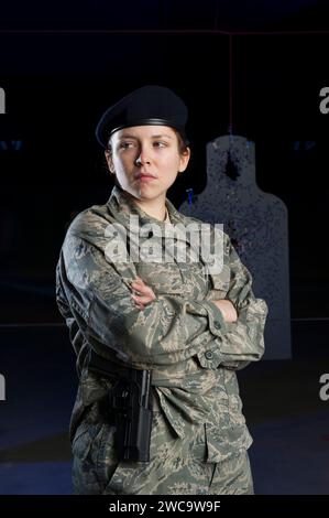 A female military police officer prepares to draw her pistol at the ...