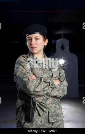 A female military police officer prepares to draw her pistol at the ...