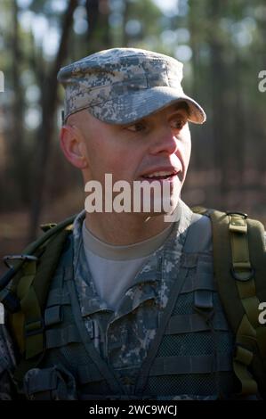 A soldier stands and instructs students during a field training ...