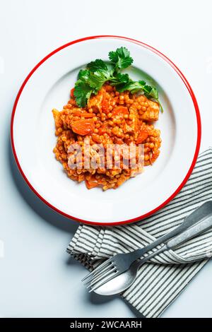 Ptitim with chicken, vegetables and cilantro, white background, close ...