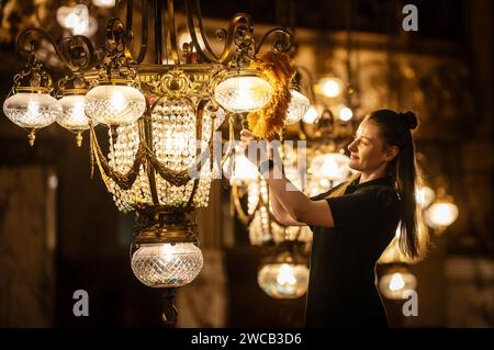 Tower ballroom team member Jennifer Allinson cleans one of the twelve ...