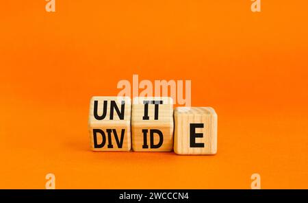 Unite or divide symbol. Concept word Unite or Divide on wooden cubes ...