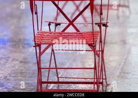 Cafe chairs, heavy rain at Times Square Stock Photo - Alamy