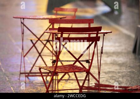 Cafe chairs, heavy rain at Times Square Stock Photo - Alamy