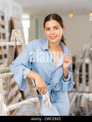Pretty cottage owner posing in room being renovated Stock Photo - Alamy