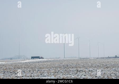 Joice, Iowa. Windmills in a winter storm with trucks rolling down the ...