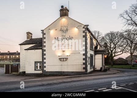 Lights come on as the sun has just gone down. This is The Maypole Inn ...