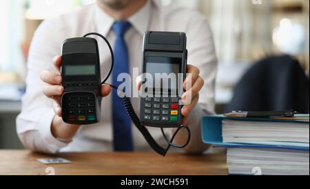 Businessman holding different pos terminals in his hands closeup Stock ...
