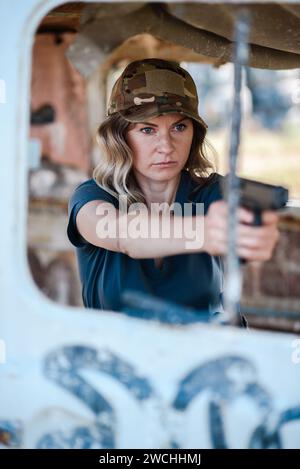 A girl with a pistol in her hand undergoes military training at a ...