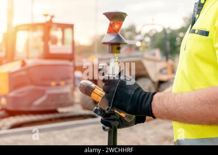 Site engineer surveyor using rugged tablet controller computer to ...