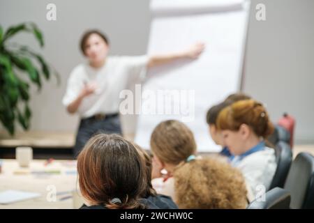 Focused audience at a corporate training session with presenter blurred ...