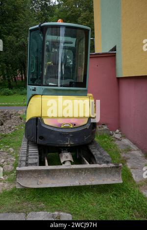 Mini excavator digging pits for optical cable Stock Photo - Alamy