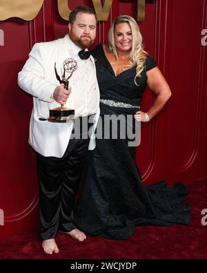 Paul Walter Hauser and his wife Amy pose together at the premiere of ...