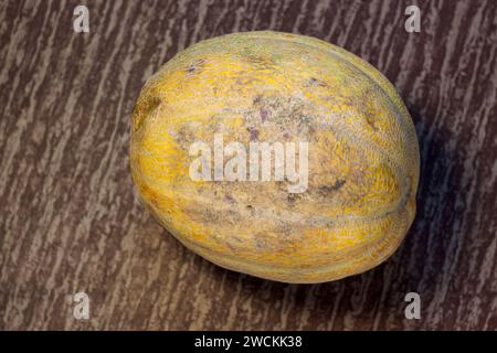 Ugly food concept. Unusual looking melon with purple and white mold ...