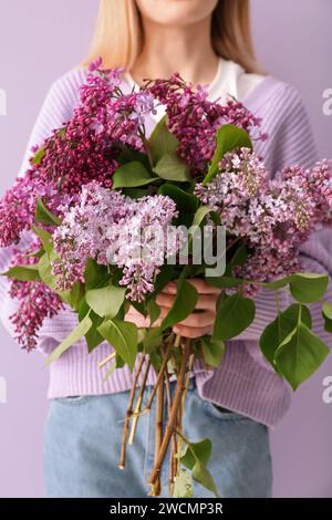 Bouquet of beautiful spring lilacs of different colors on a wooden ...
