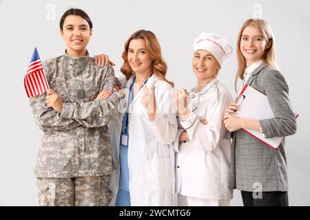 Women of different professions on grey background Stock Photo - Alamy