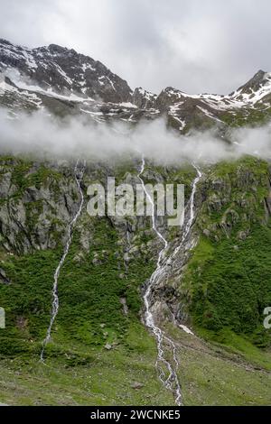 Mountain streams flow over steep mountain slopes into the tagl of the ...