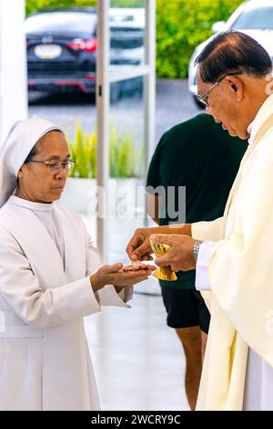 A priest giving the Holy Communion to the faithful Stock Photo - Alamy