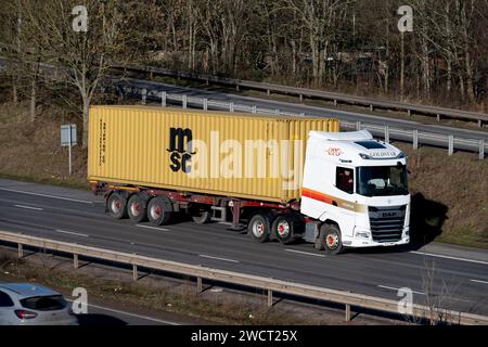 MSC shipping container on articulated skeletal trailer towed by ...