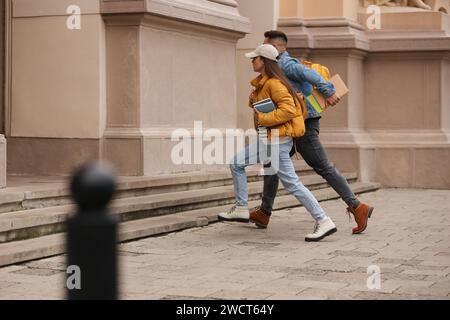 Being late. Students running towards building outdoors Stock Photo - Alamy